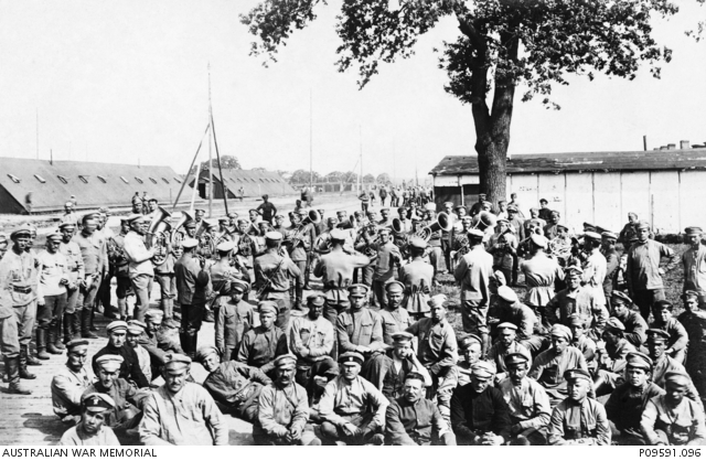 A large group of unidentified prisoners of war (POW) surrounding a ...