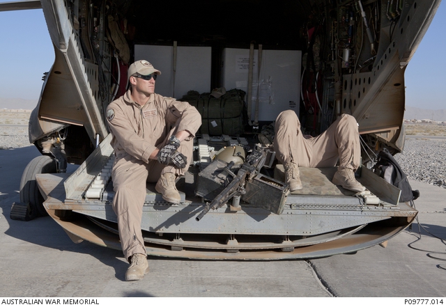 Matthew Dobson and an unidentified air crewman rest on the rear ramp of ...