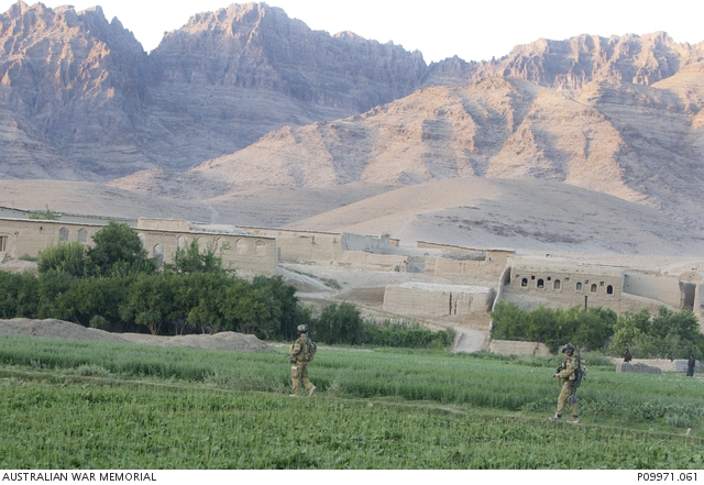 OMLT Delta, on patrol from Parol Base Razaq, pass an Afghan village ...