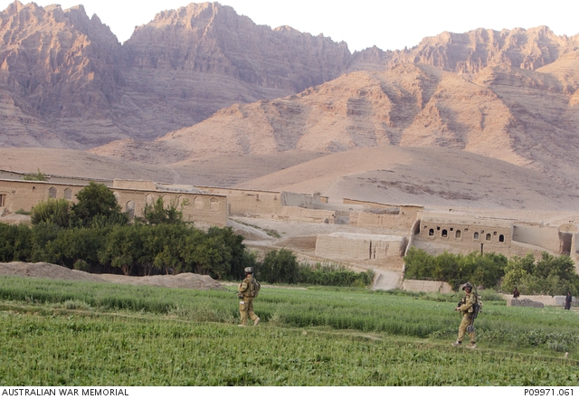 OMLT Delta, on patrol from Parol Base Razaq, pass an Afghan village ...