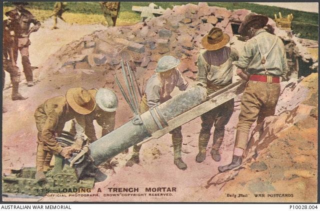 'Loading a trench mortar'. Five members of an Australian trench mortar ...