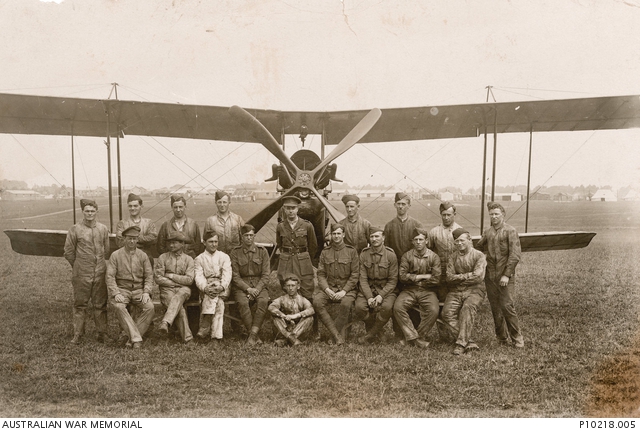 Outdoors formal group portrait of an unidentified AFC captain and men ...