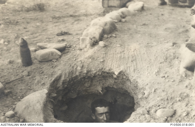 "Capt. [Captain] Dodd looking out of Signals Office through the shell ...