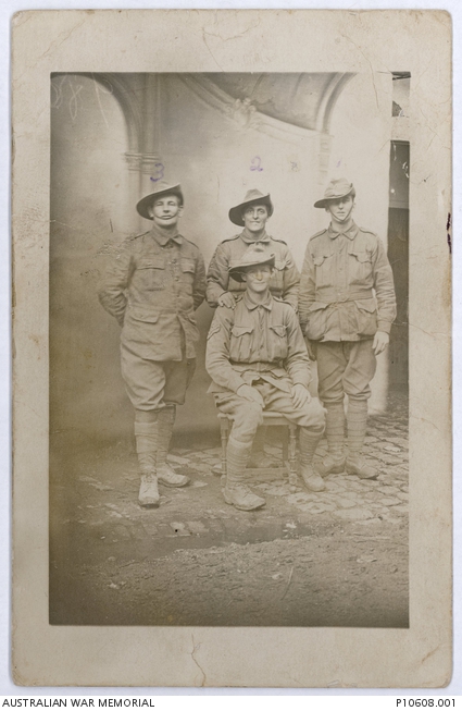 Studio portrait of four members of the 50th Battalion AIF. Standing in ...