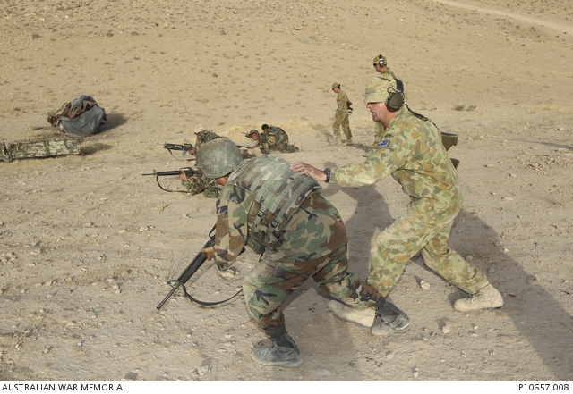 A member of Mentoring Task Force Three (MTF-3) teaching an Afghan ...