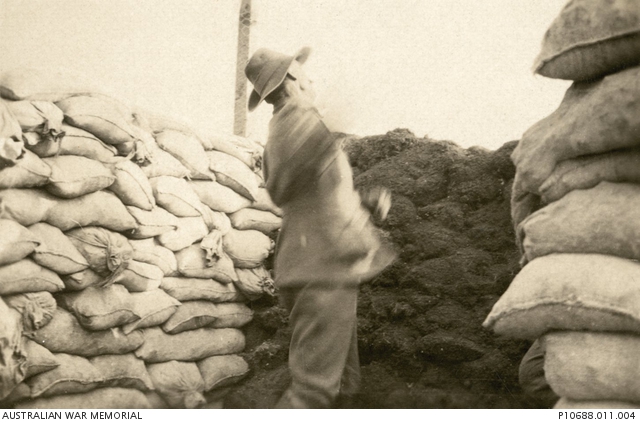 An unidentified Australian soldier throwing a Mills bomb, at the ...