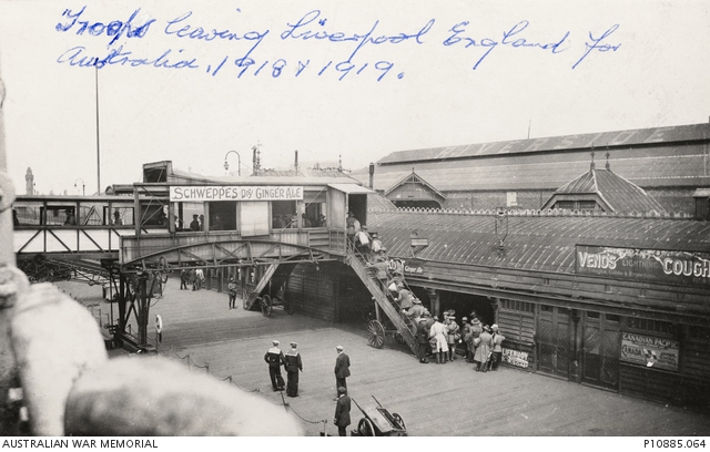 Troops crossing the bridge onto a ship, believed to be the SS Persic ...