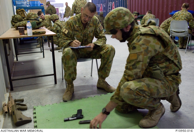 ADF personnel undertake weapons loading and unloading training at a ...