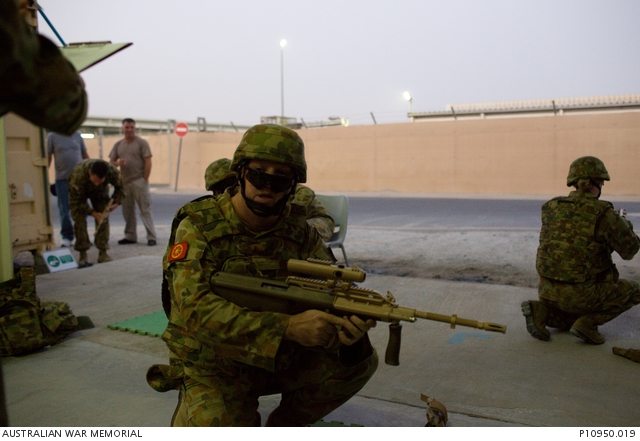 ADF personnel undertake weapons loading and unloading training at a ...