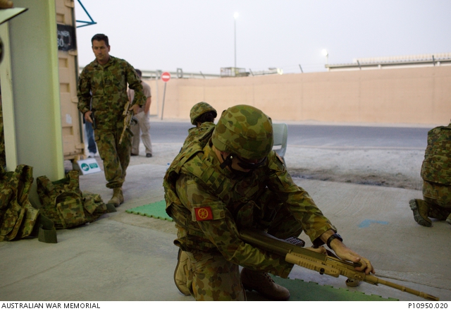 ADF personnel undertake weapons loading and unloading training at a ...
