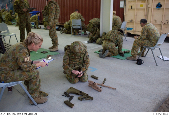 ADF personnel undertake weapons loading and unloading training at a ...