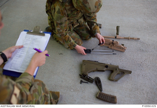 ADF personnel undertake weapons loading and unloading training at a ...