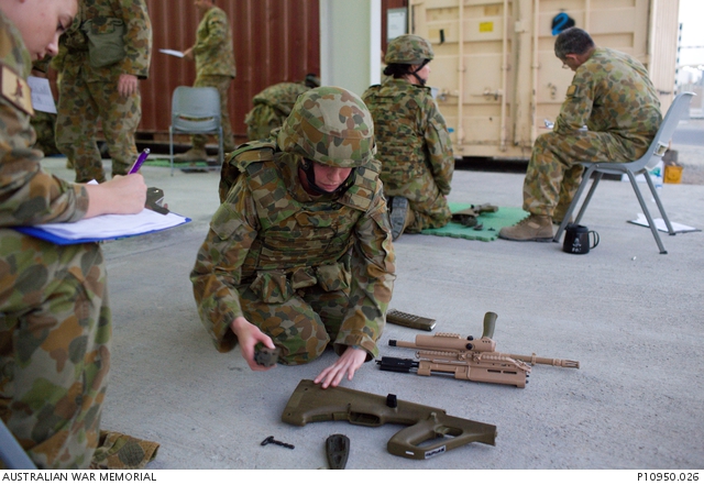ADF personnel undertake weapons loading and unloading training at a ...