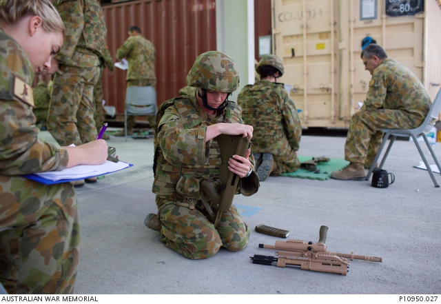 ADF personnel undertake weapons loading and unloading training at a ...