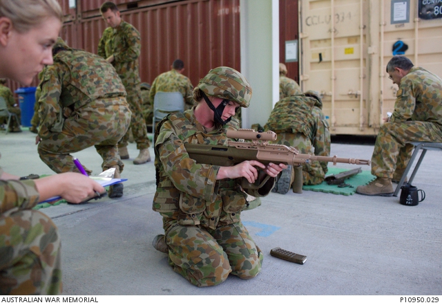 ADF personnel undertake weapons loading and unloading training at a ...