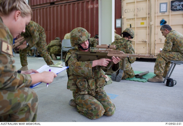ADF personnel undertake weapons loading and unloading training at a ...