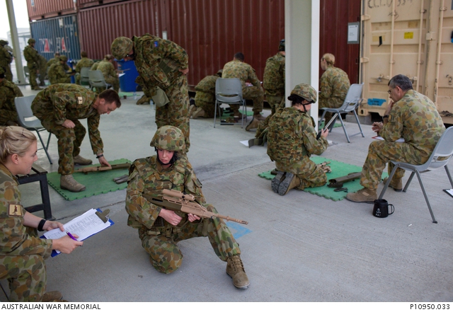 ADF personnel undertake weapons loading and unloading training at a ...