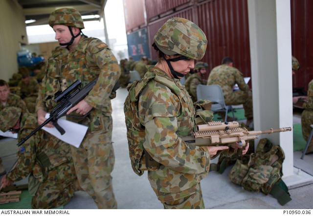 ADF personnel undertake weapons loading and unloading training at a ...