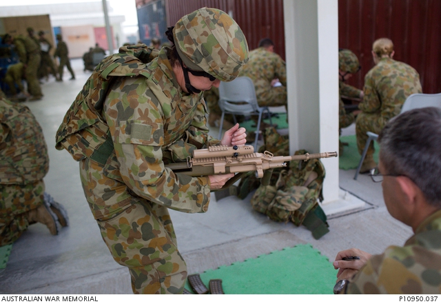 ADF personnel undertake weapons loading and unloading training at a ...