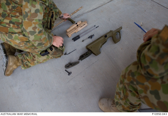 ADF personnel undertake weapons loading and unloading training at a ...