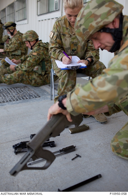 ADF personnel undertake weapons loading and unloading training at a ...