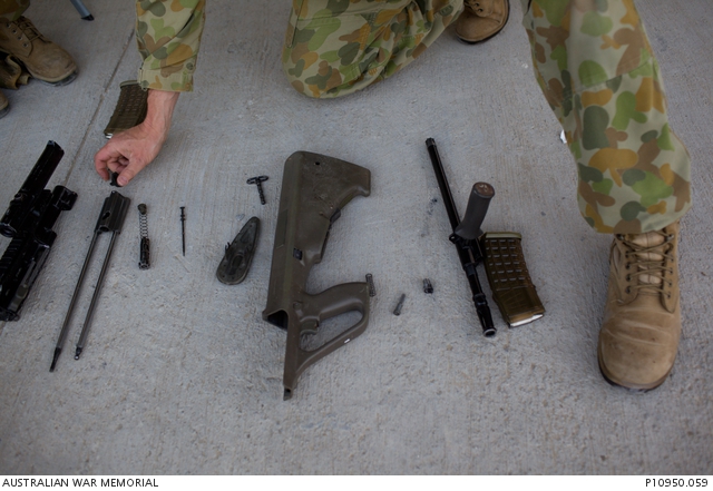 ADF personnel undertake weapons loading and unloading training at a ...