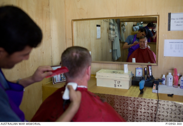 Captain Scott Gayton, 1st Psychology Unit (1 Psych), having his hair ...