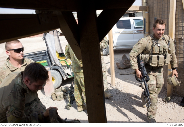 Members of the ADF wear full mission kits, body armour and weapons ...