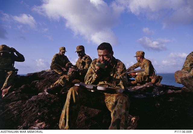 Members of the 51st Battalion Far North Queensland Regiment (FNQR) rest ...