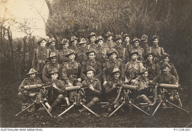 Outdoor group portrait of a section of 12th Brigade machine gunners ...