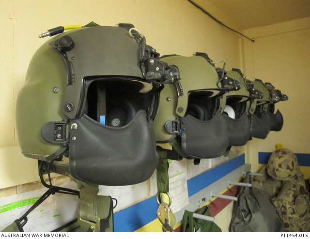 A row of helmets fitted with dust masks. One of a series of ...