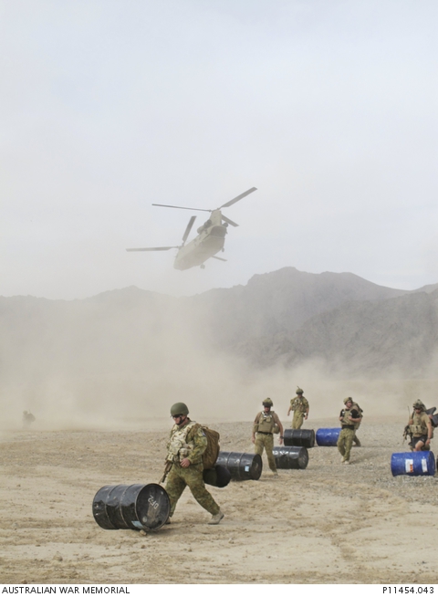 Australian soldiers rolling barrels of oil for the generators at Patrol ...