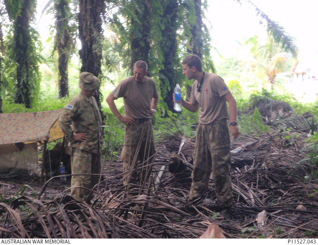 Three unidentified members of 23 Charlie at the Forward Operating Base ...