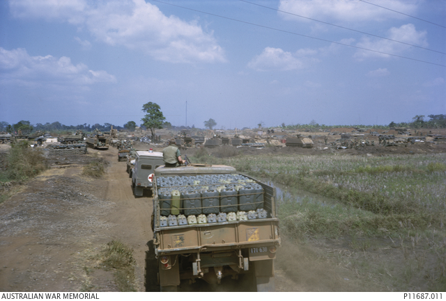 A convoy of trucks carrying supplies, including a medical van, enters ...
