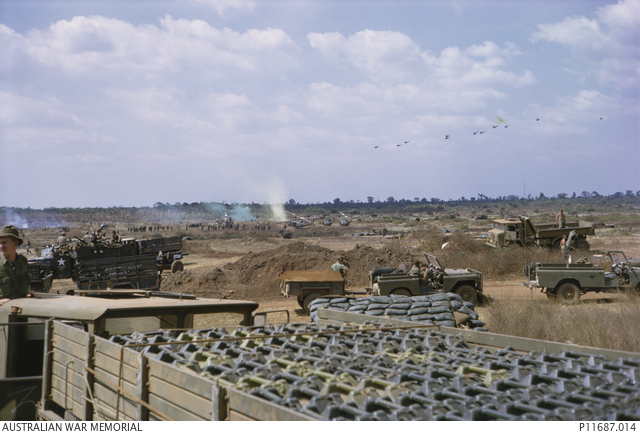 A convoy of trucks carrying supplies enters Fire Support Base Andersen ...