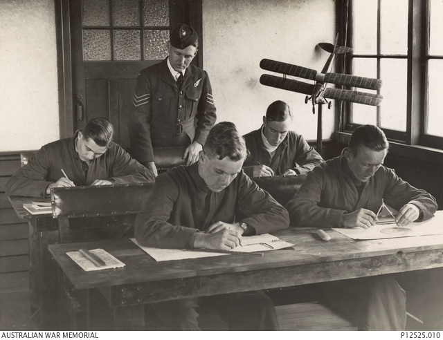 Group portrait of members of No. 21 Squadron, RAAF being briefed by ...