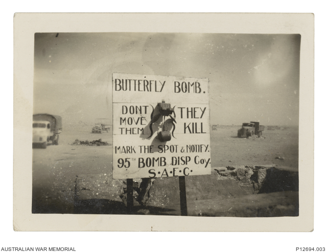 A wooden sign at El Alamein with an example of a German butterfly bomb ...