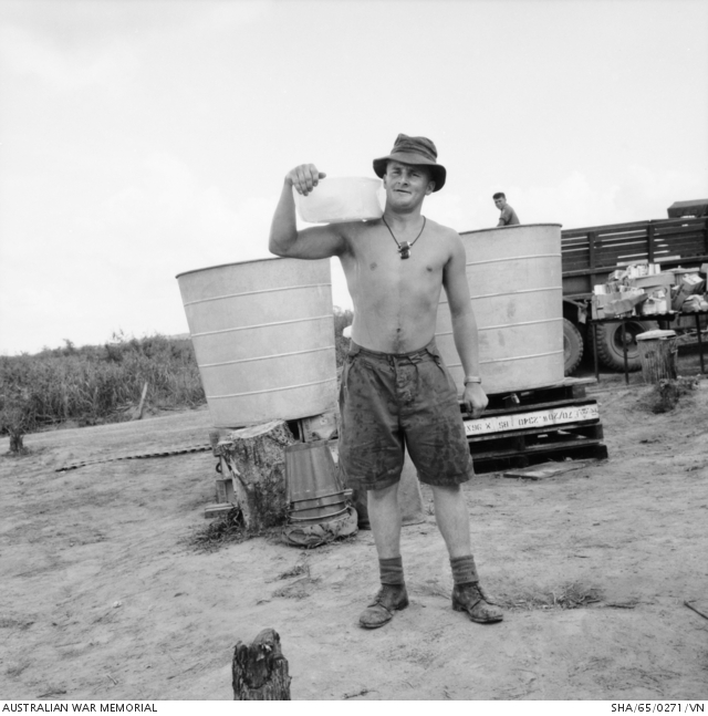 Bien Hoa, Vietnam. 1965-12. Bare-chested Gunner John Gourlay of Hobart ...