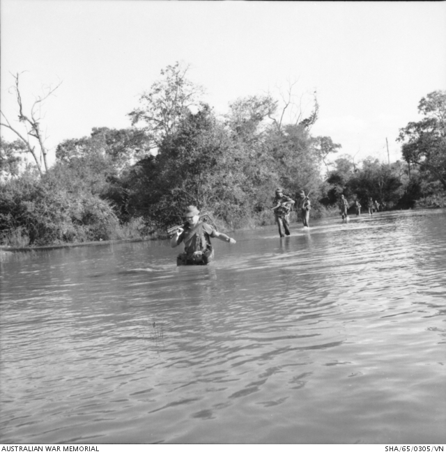 Wading across the Song La-Nga river near the village of Vo Xu during ...