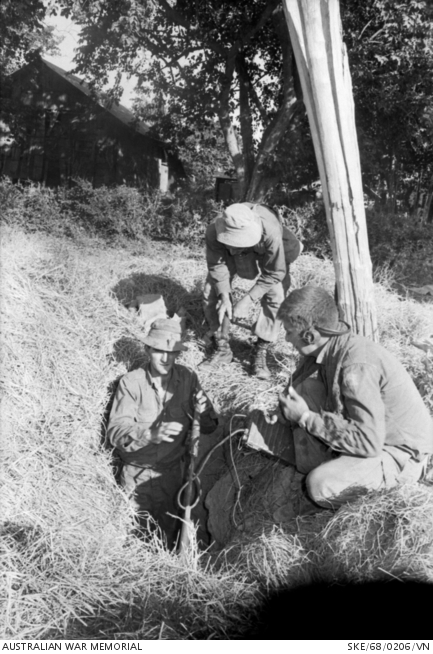 Long Dien, South Vietnam. 1968-02. A short tunnel under a haystack is ...
