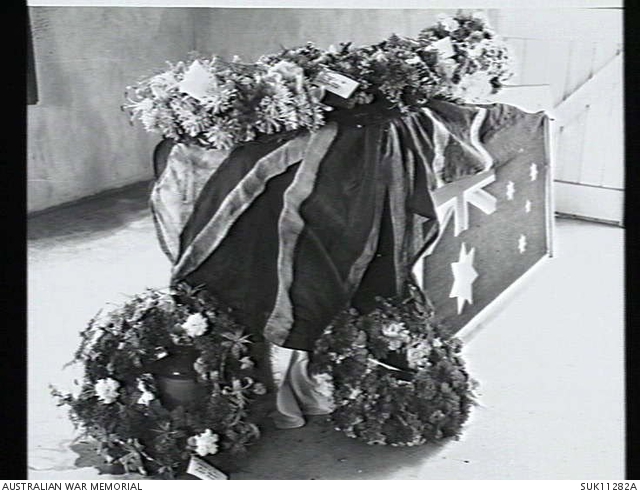 England. 1943-08-07. The flag draped coffin covered with wreaths at the ...