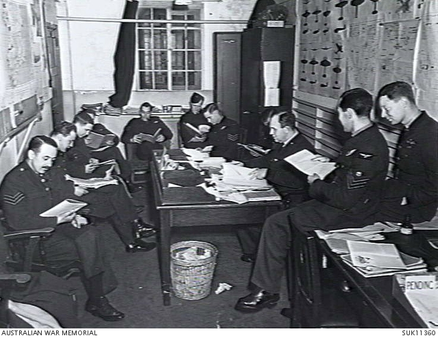 England. C. 1943-05. In the Intelligence room of No. 120 Squadron RAF ...