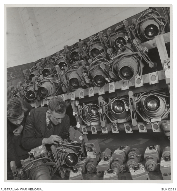 England. C. 1944-04. Photographers preparing aerial cameras for ...