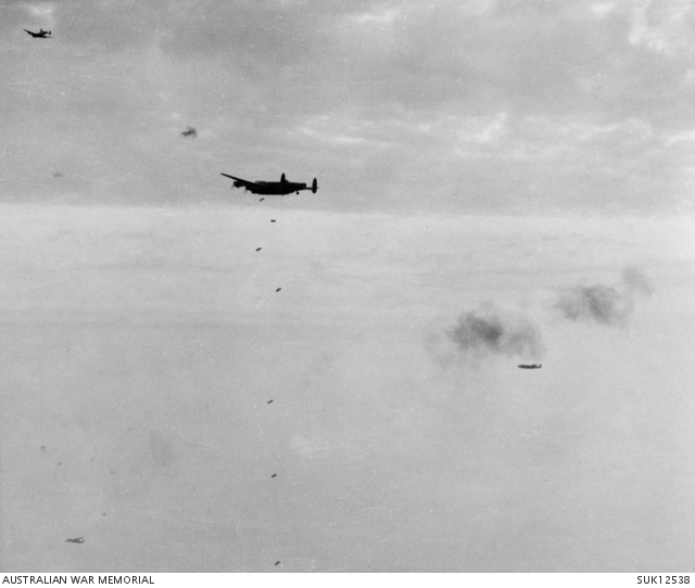 France. 1944-06-18. Bombs leave a Lancaster flying through a flak ...