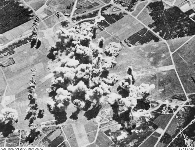 Holland. 1944-08-15. Bombs seen bursting on the airfield at Gilze-Rijen ...