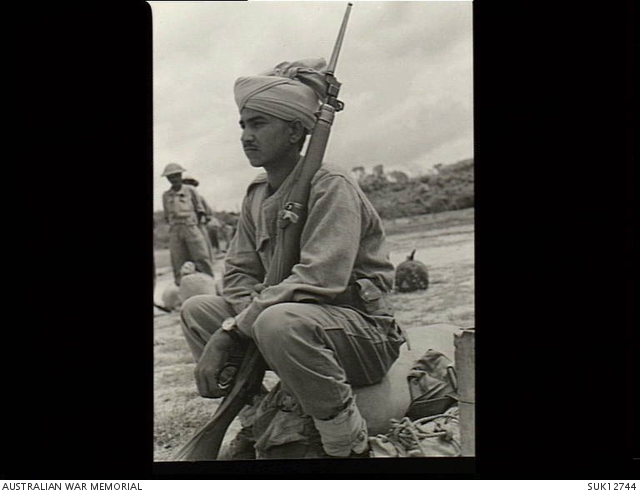 India. C. 1944-08. Sikh rifleman awaiting his turn to embark in an ...