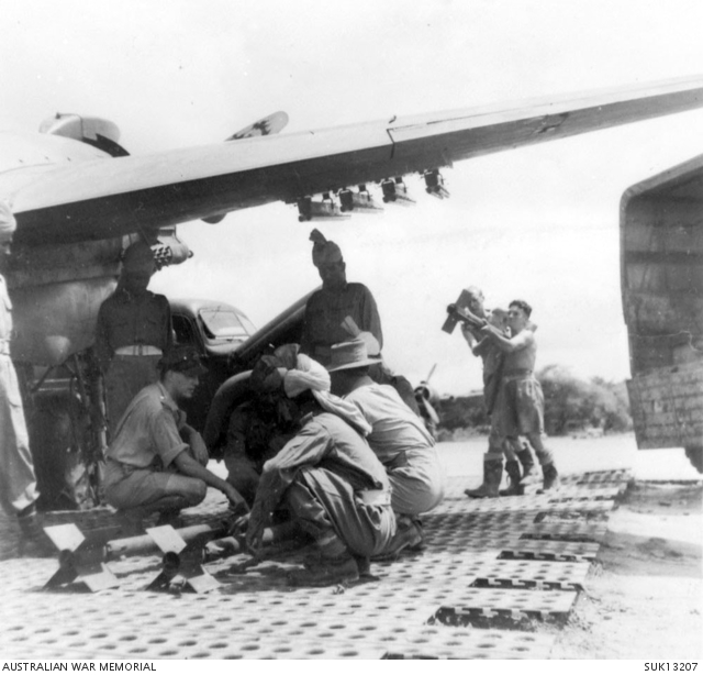 Burma. C. 1944-10. An RAF Beaufighter aircraft being loaded with ...