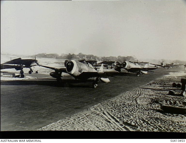 Burma. C. 1944-11. RAF Thunderbolt aircraft taxiing out past a line up ...