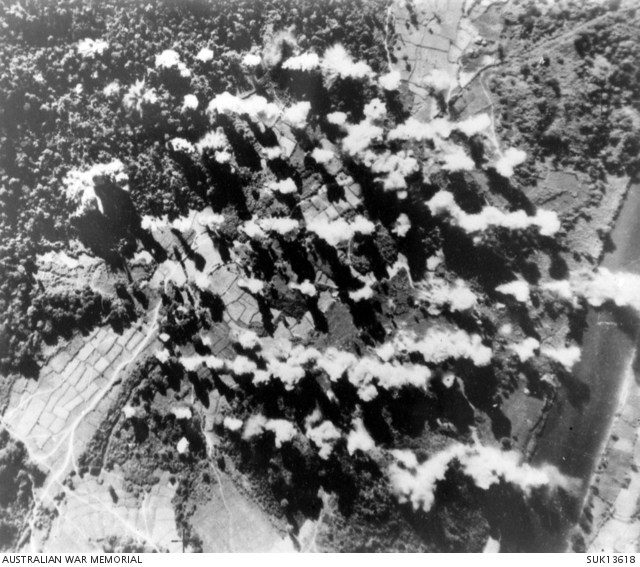 Taungup, Burma. C. 1945-01. Bombs dropping from RAF Liberator bomber ...