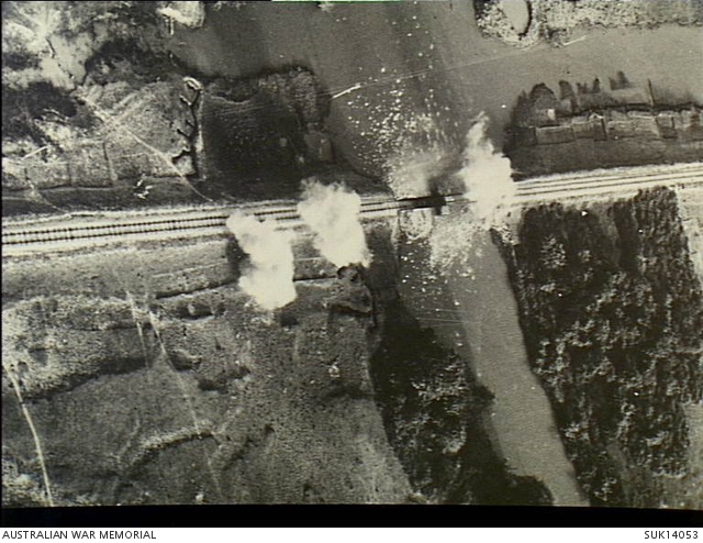Kalawthut, Burma. C. 1945-04. Bomb bursts on and near the bridge close ...